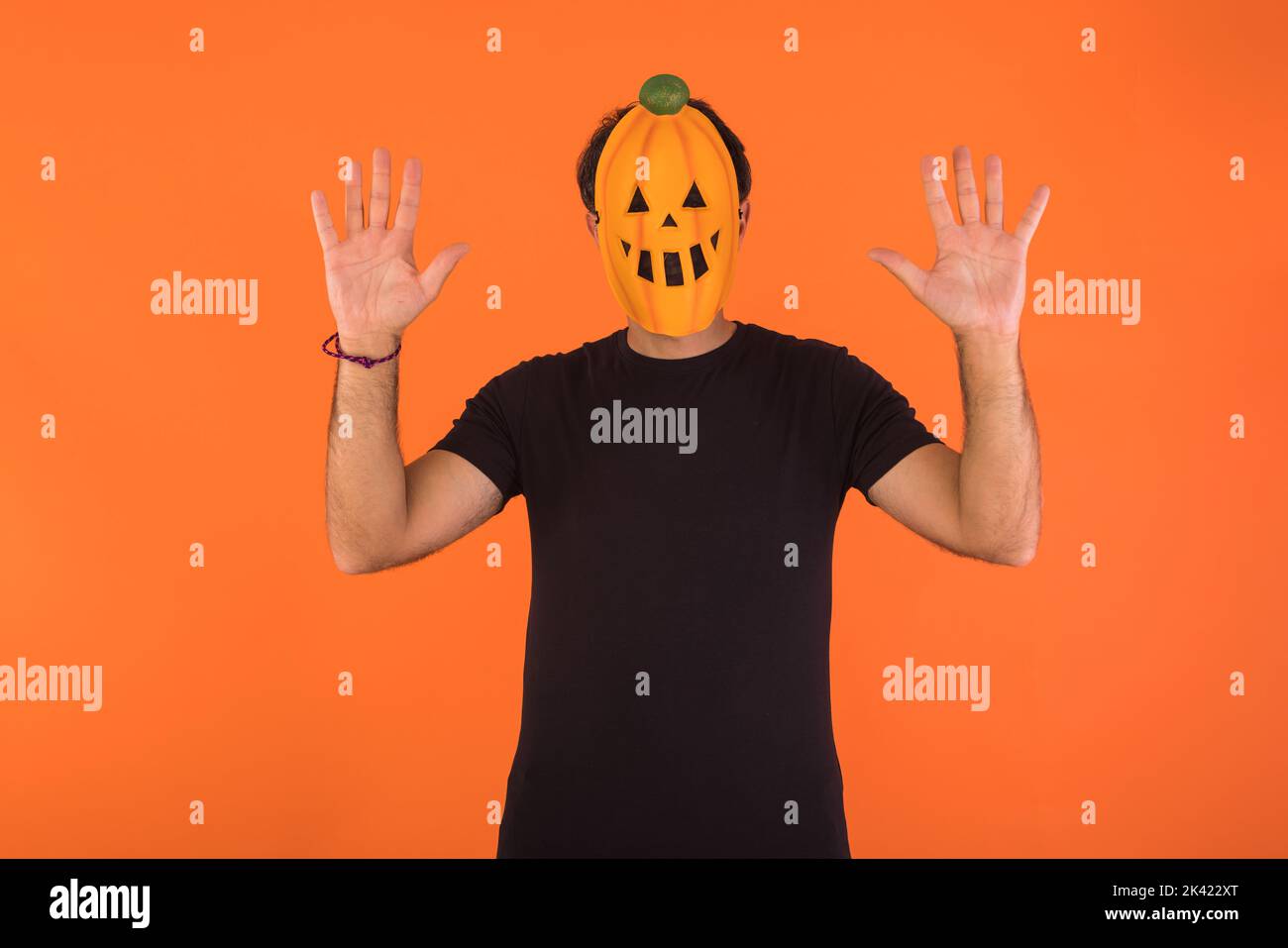 Person with pumpkin mask celebrating Halloween, raising hands. Concept ...