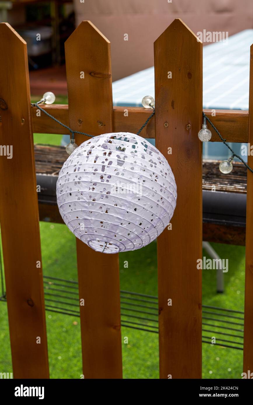 Round paper hanging lamp in outdoor garden Stock Photo - Alamy