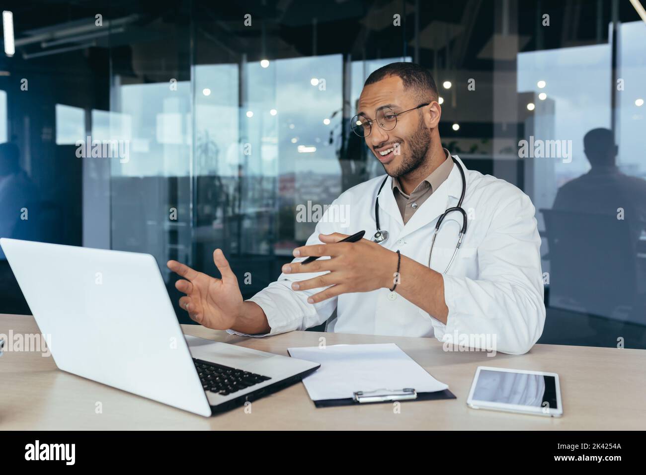 Cheerful african american doctor talking on video call, man using ...