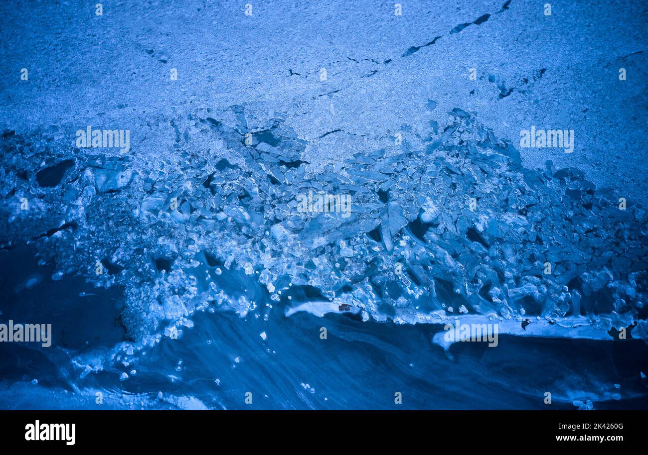 Aerial top view from above of frozen sea glaciers at the beach. Cracked ...
