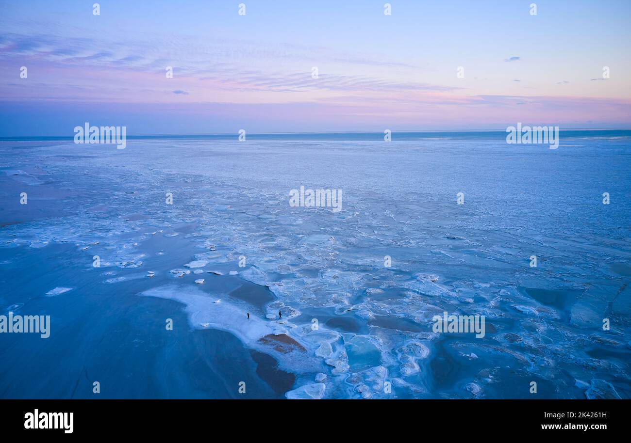 Aerial view of sunset over the frozen sea. Winter landscape on seashore ...