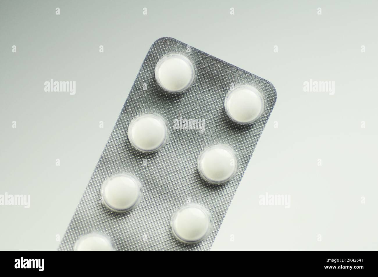 White tablets of medication in a blister package Stock Photo - Alamy