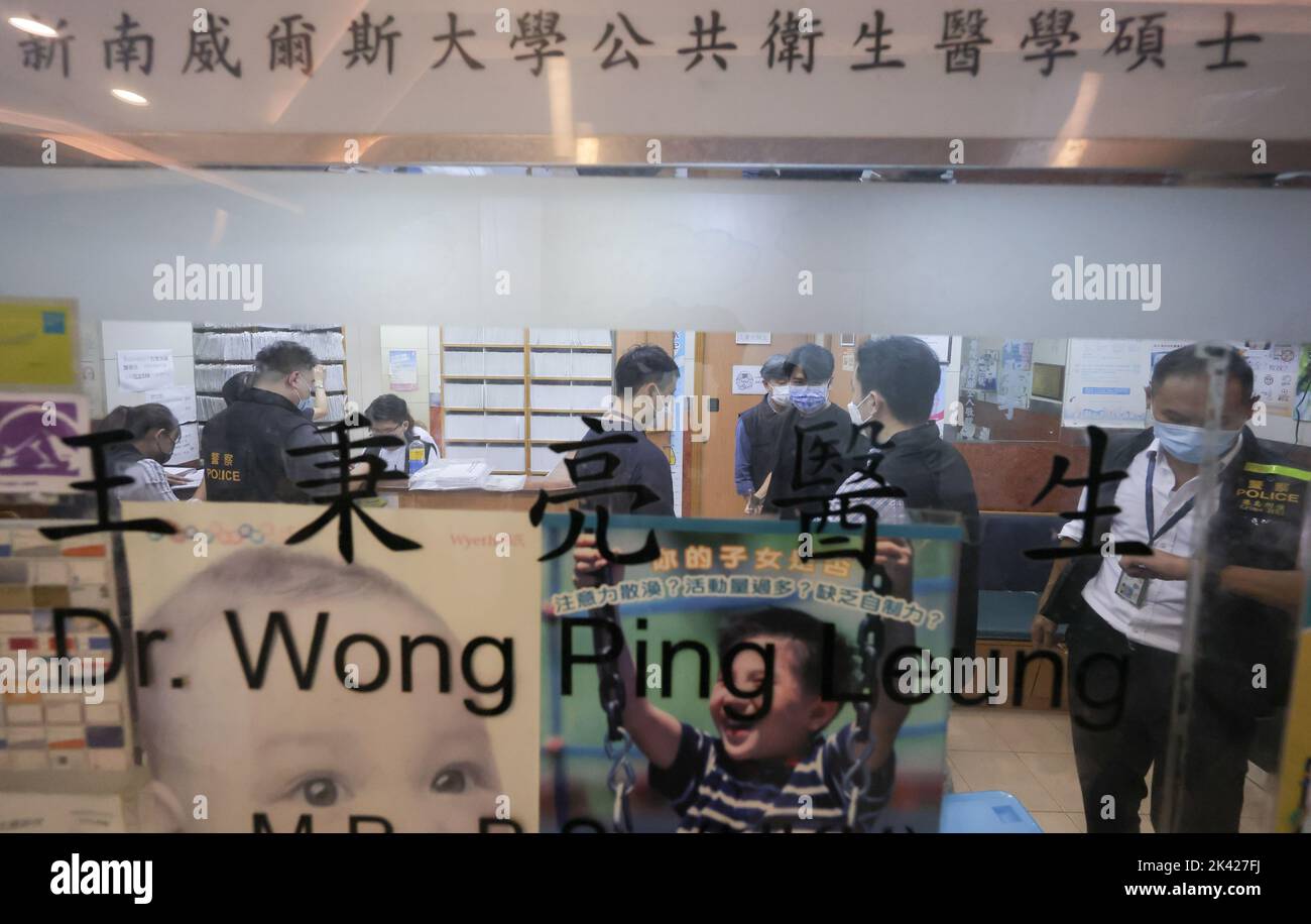 Police officers investigate at the clinic of Doctor Wong Ping-leung in ...