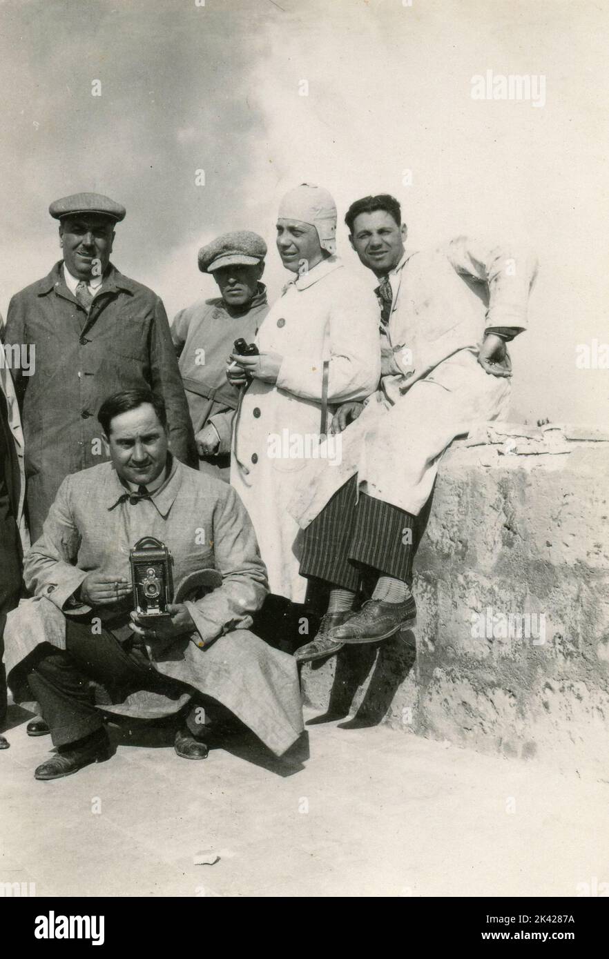 Five friends along the road during a car trip, Italy 1920s Stock Photo ...