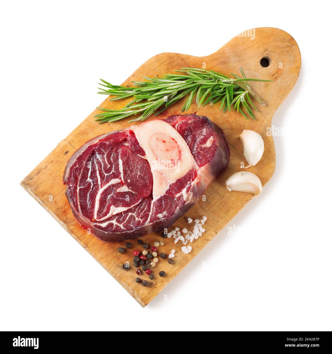 Fresh raw meat beef steak with bone with spices, rosemary, garlic and ...
