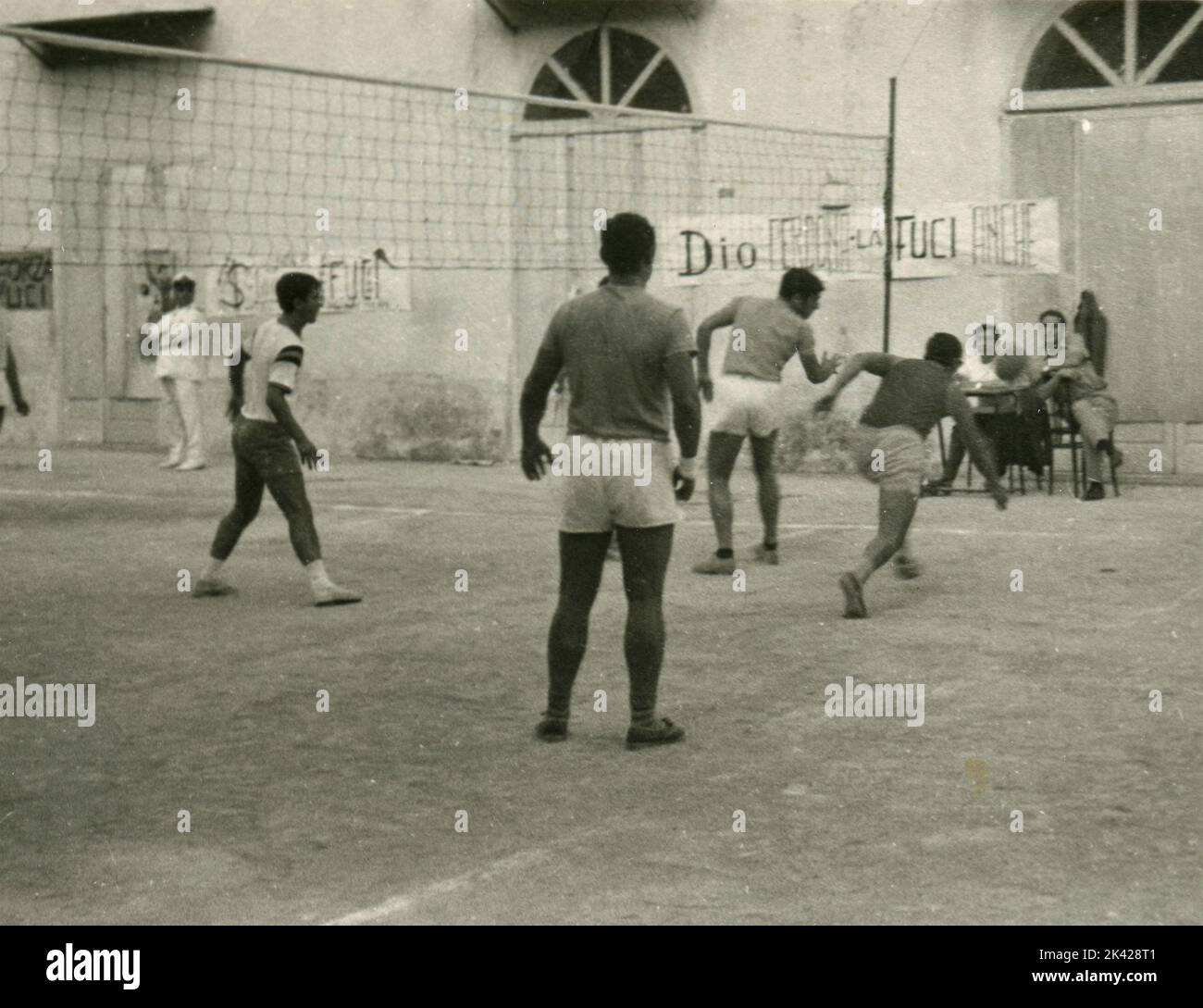Boys playing wolleyball in a Catholic FUCI field, Italy 1968 Stock ...