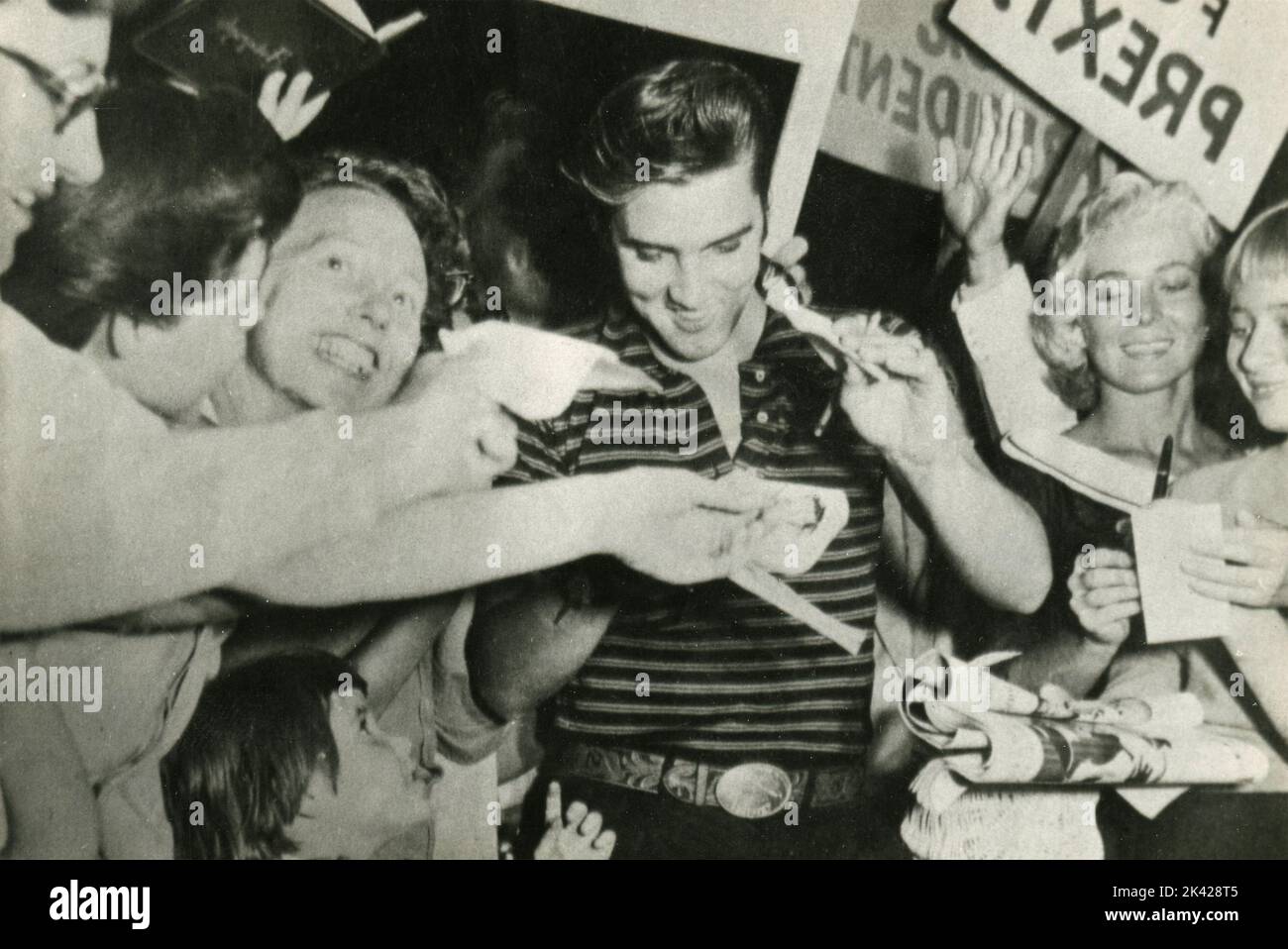 American singer and actor Elvis Presley signing autographs, USA 1950s ...