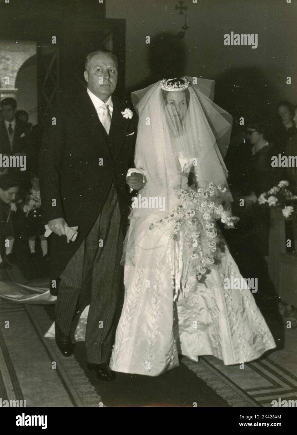 The Father of the bride takes her to the altar of the church, Italy ...