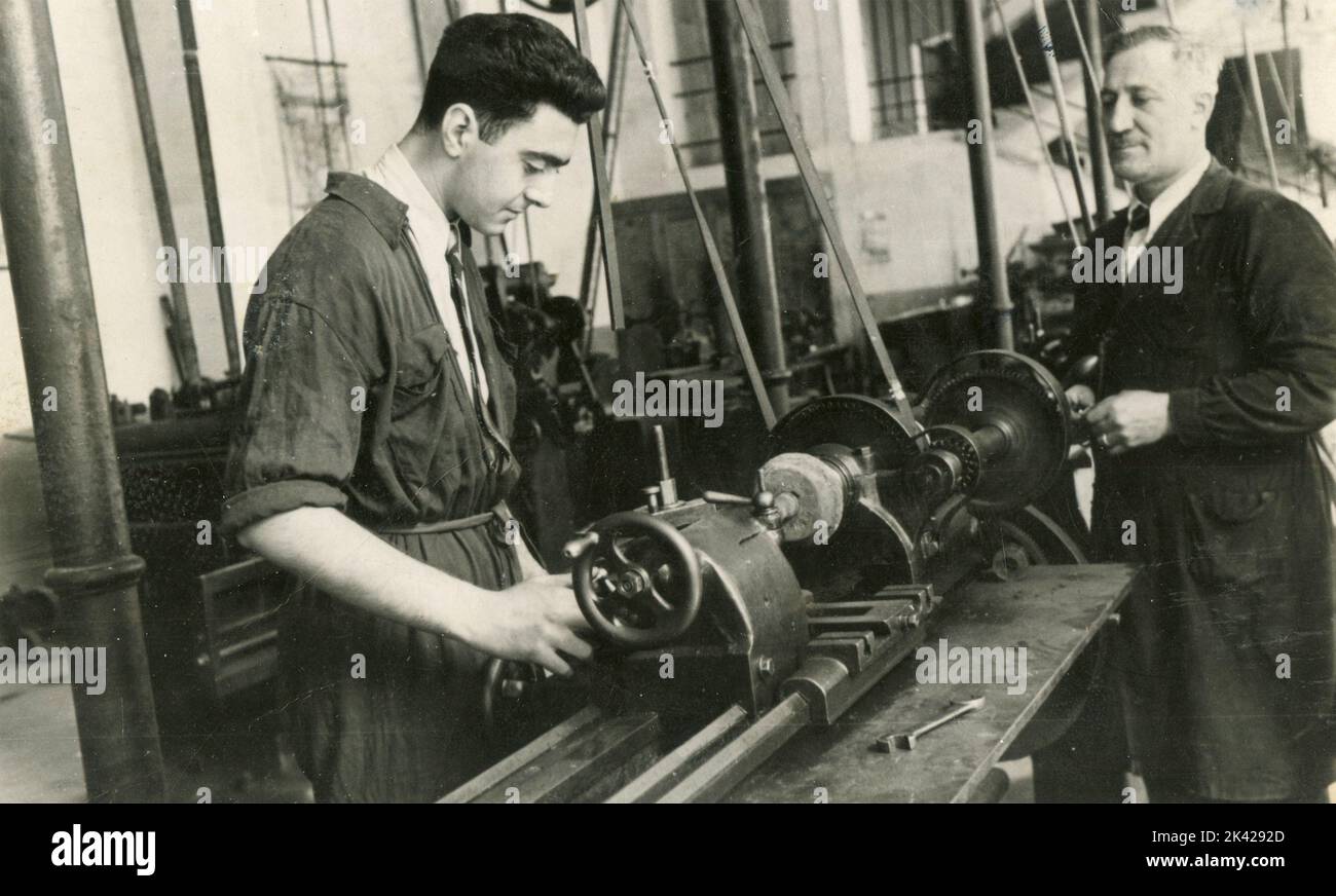 Turner man working at the tower in a factory, Italy 1950s Stock Photo ...