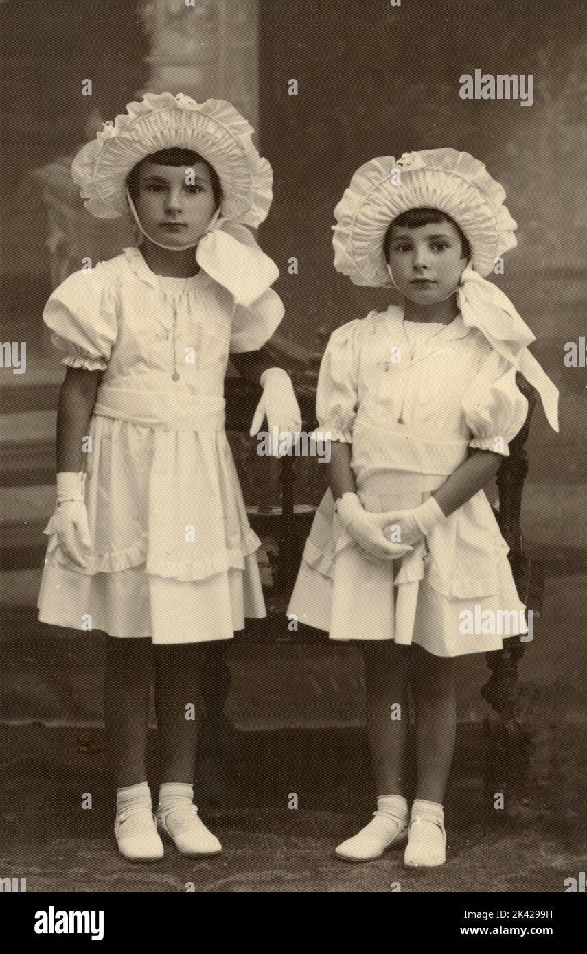 Studio portrait of two children sisters dressed alike, Italy 1930s ...