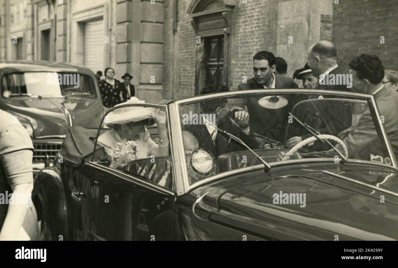 Just married couple inside a convertible car, Italy 1951 Stock Photo ...