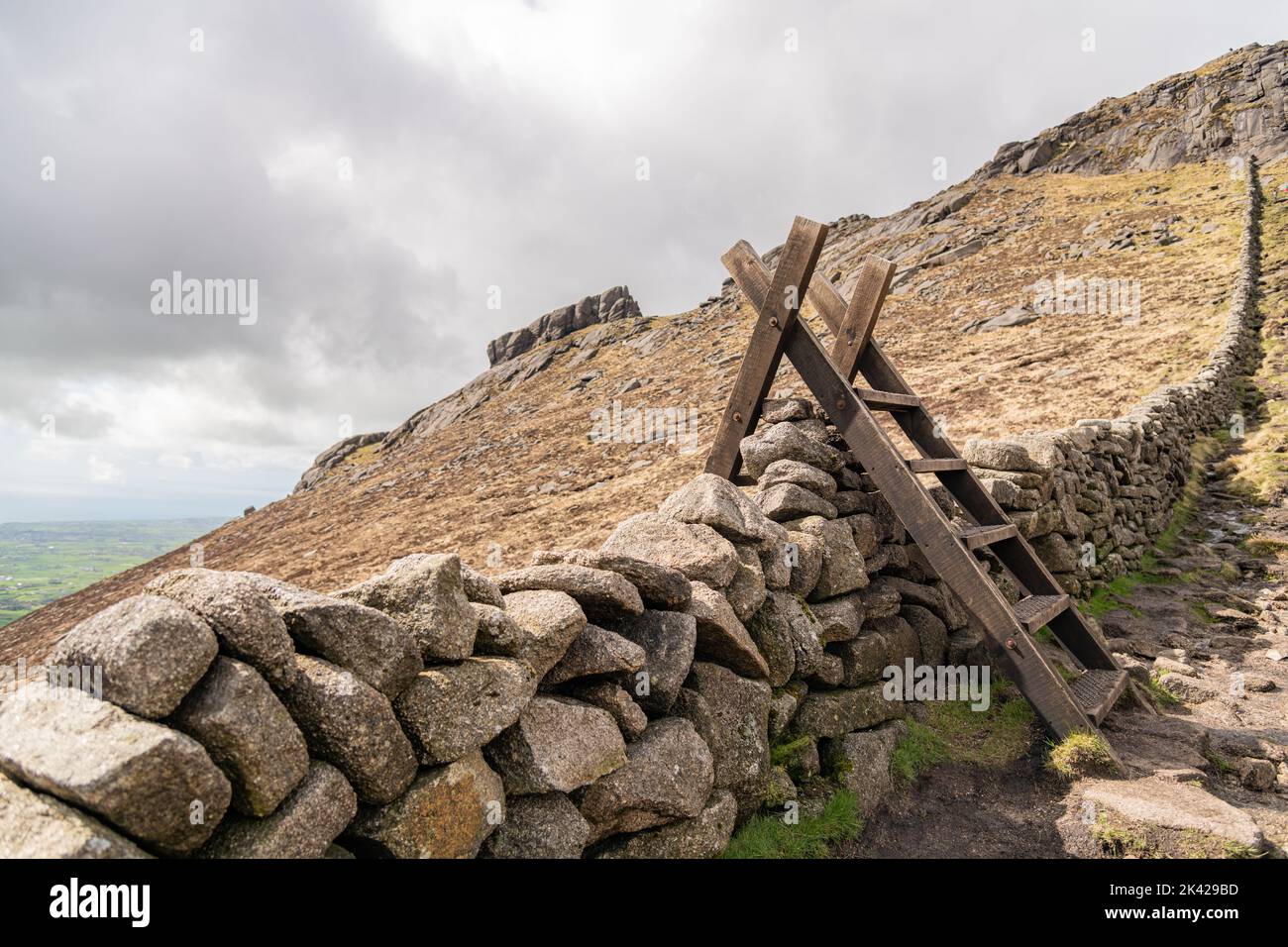 A stile over a stone wall in the Mourne Mountains in Northern Ireland ...