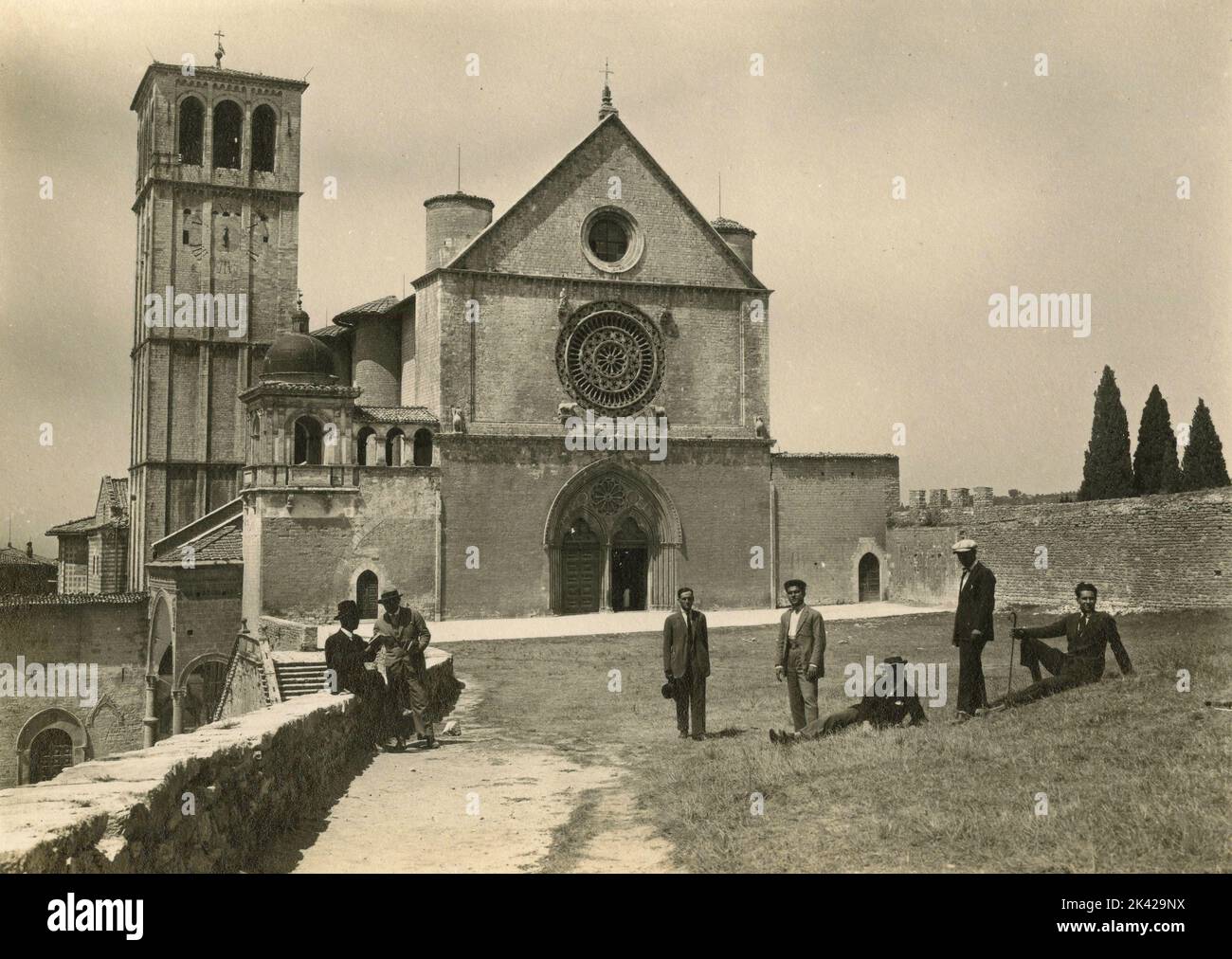 Group of men outside the Basilica St. Francis of Assisi, Italy 1920s ...