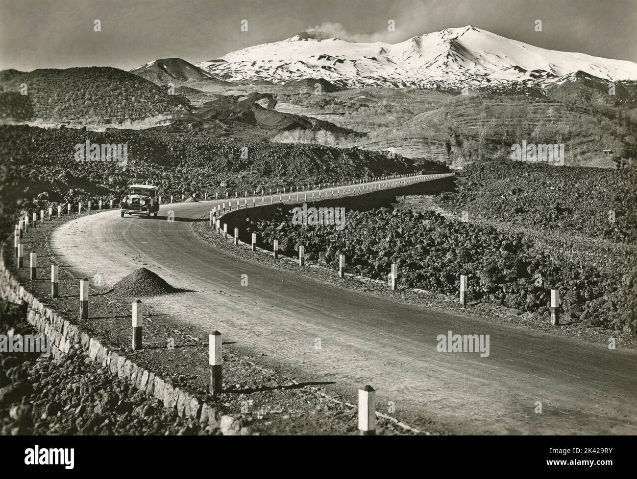 A car driving the new road to the Etna volcano, Sicily, Italy 1937 ...