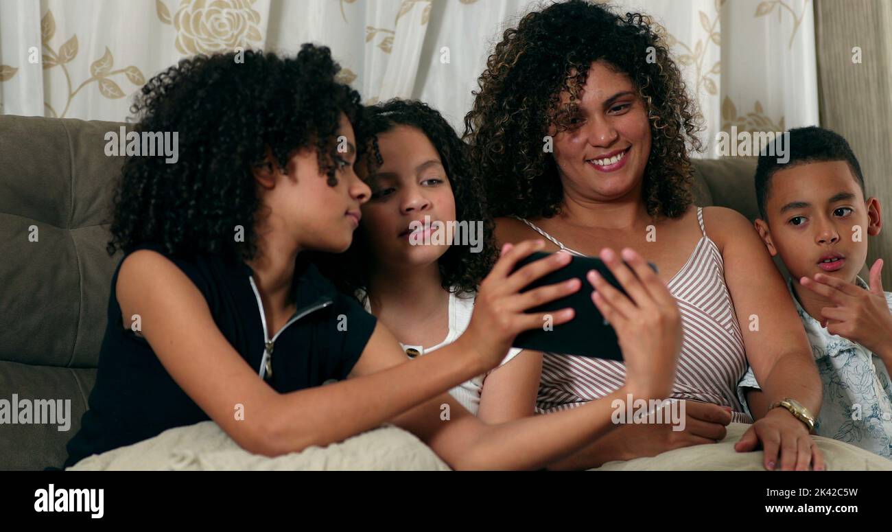 Brazilian family speaking communication tablet device with children ...