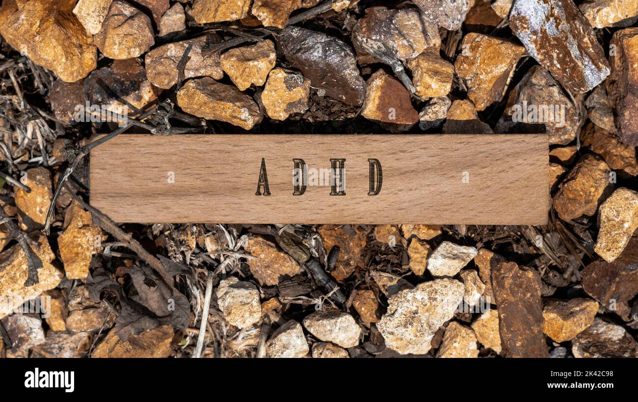 ADHD disease. Written on wooden surface. Wooden frame on pieces of ...