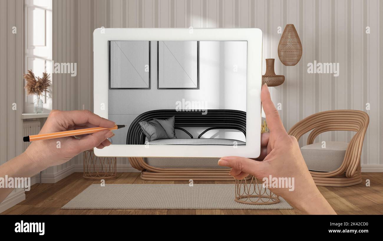 Hands holding and drawing on tablet showing modern rattan living room ...