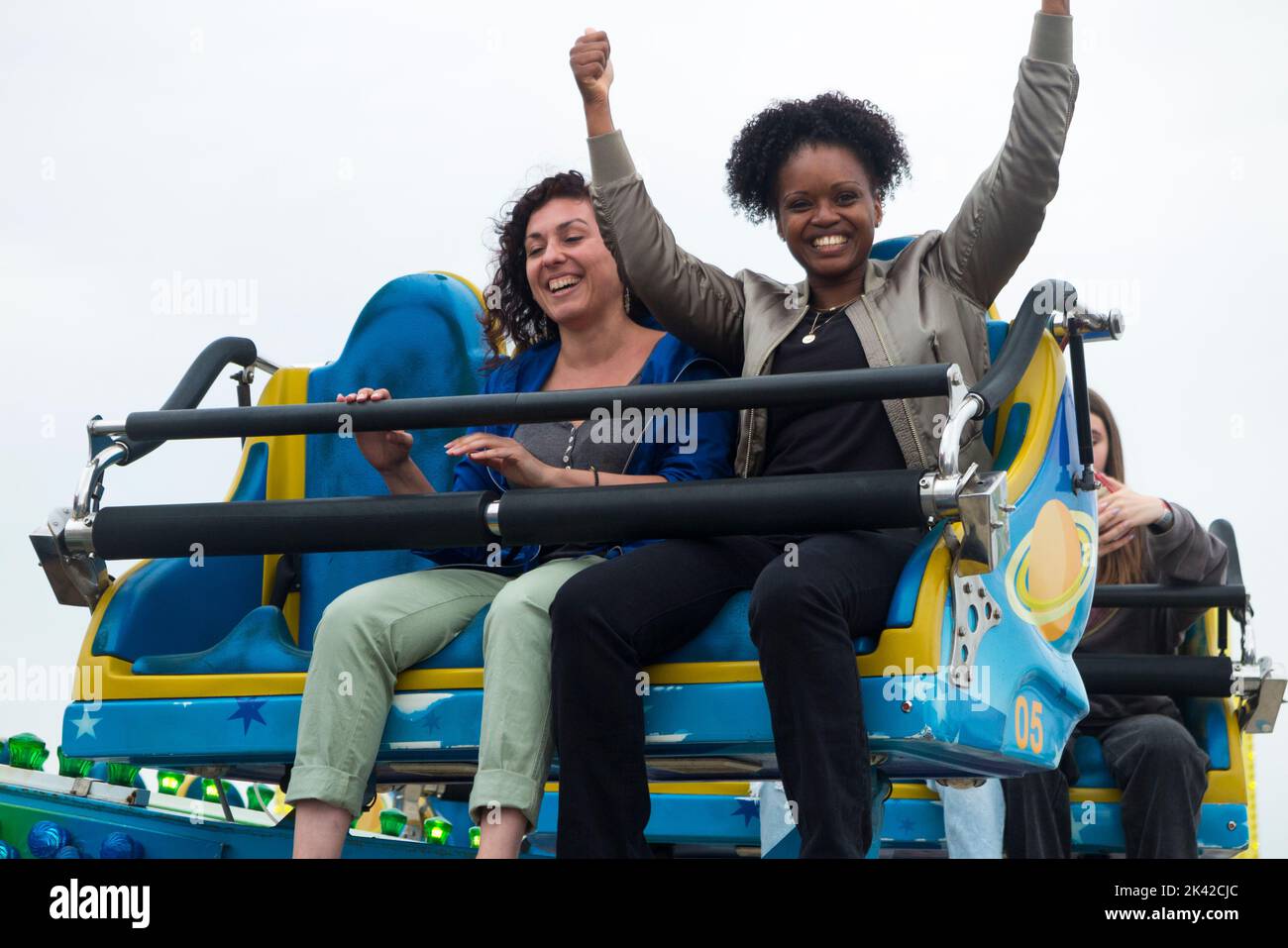Smiling fairground ride celebrating hi-res stock photography and images ...