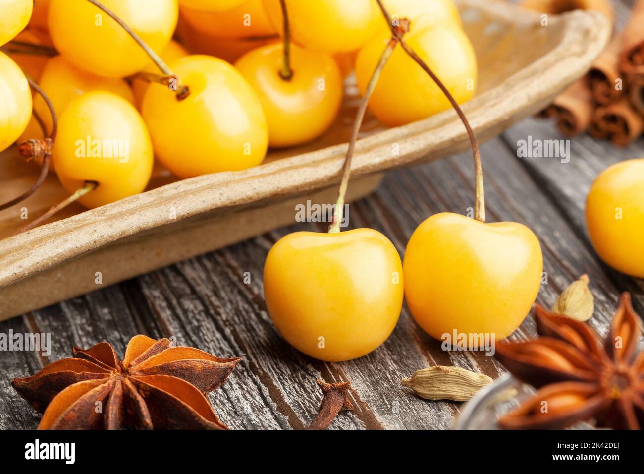 yellow cherry on wood background Stock Photo - Alamy