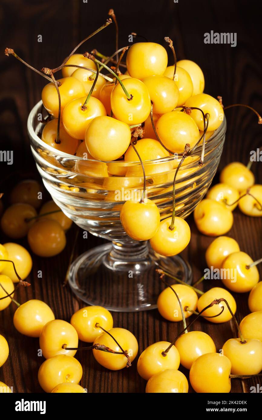 yellow cherry on dark wood background Stock Photo - Alamy