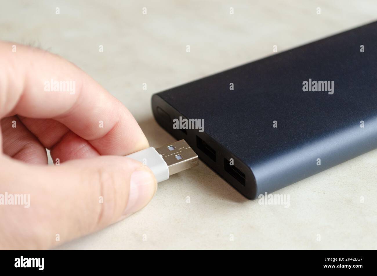 man inserts usb cable into powerbank.Charging mobile gadget Stock Photo ...