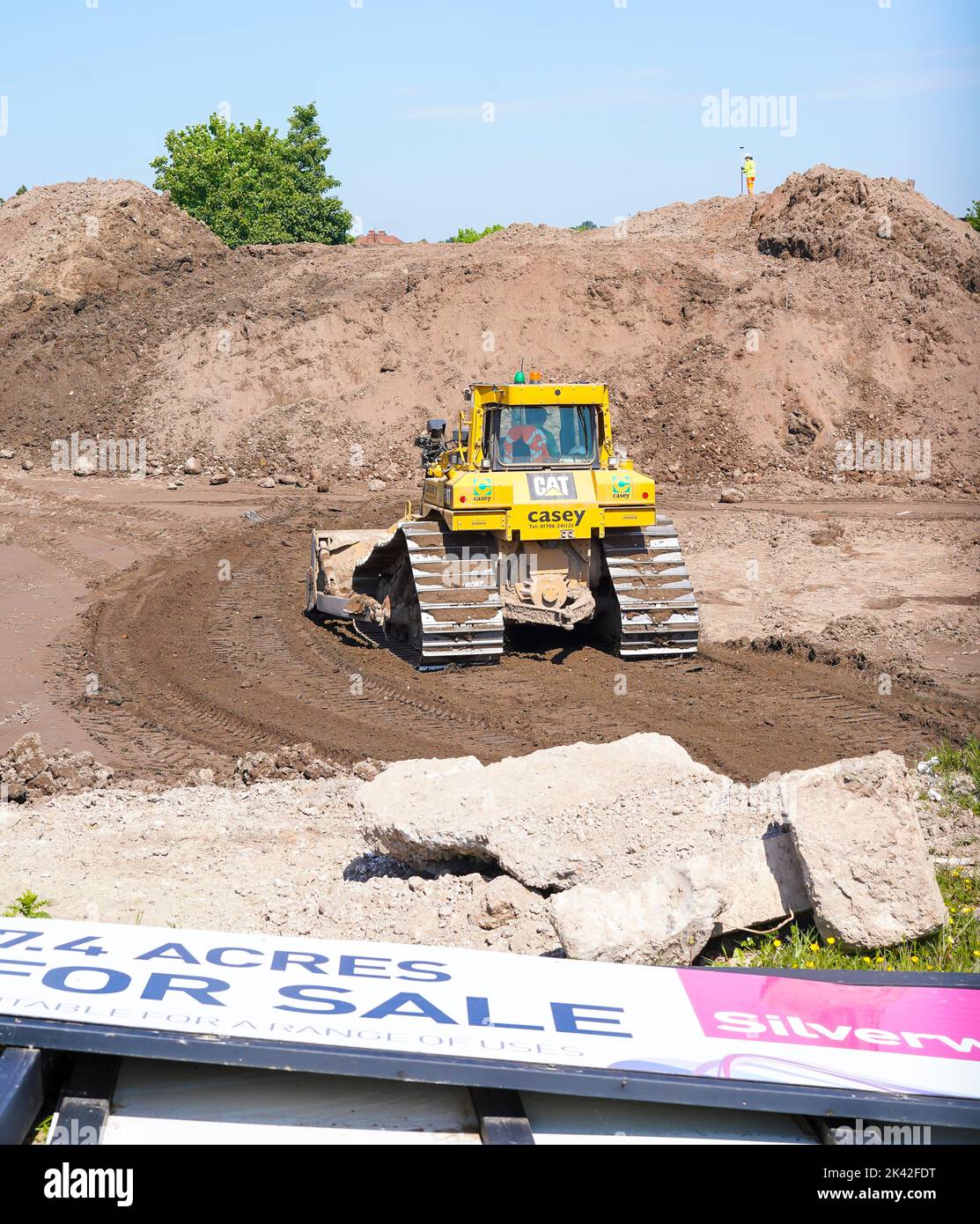 A bulldozer preparing groundworks for a building site homes development ...