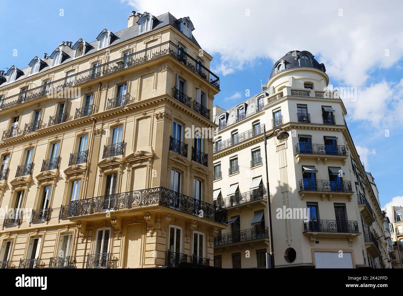 The facades of traditional French houses with typical balconies and ...