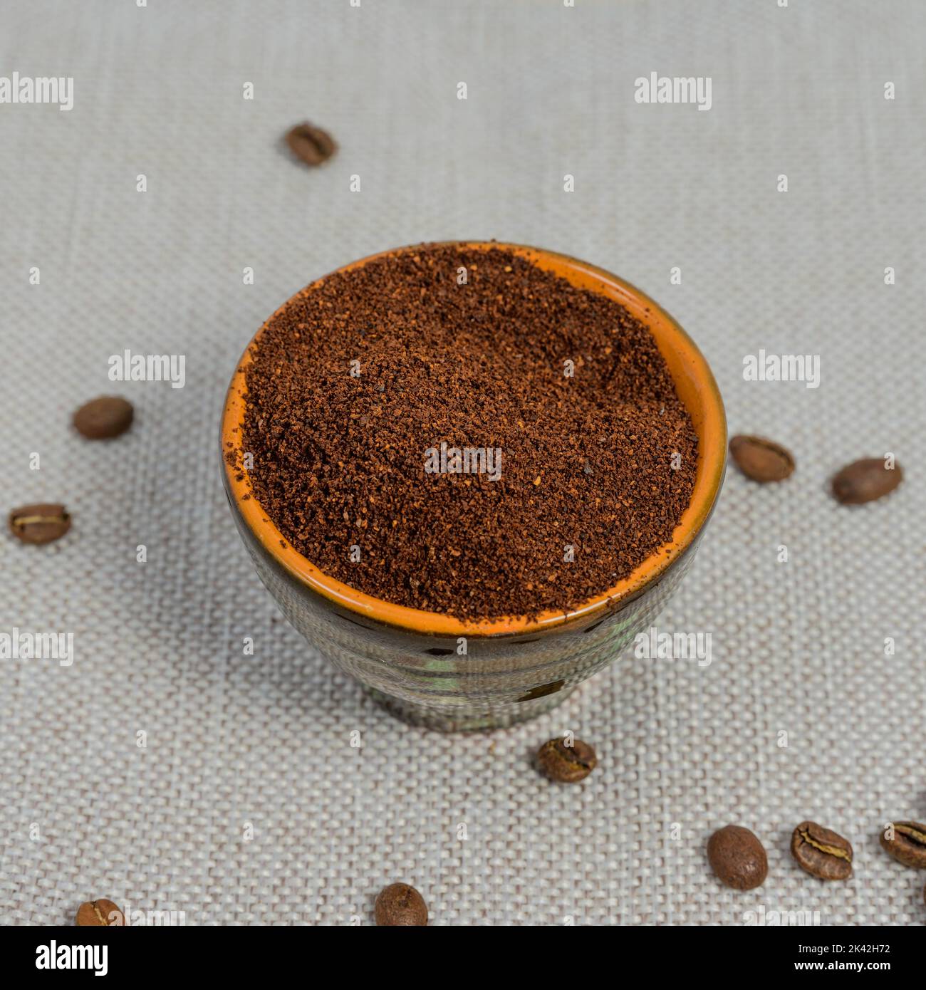 coffee beans, ground coffee in cups on a linen background, an aromatic ...