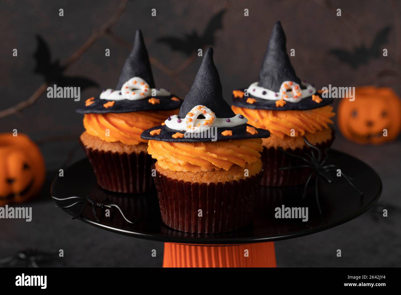 Halloween cupcakes decorated witch hat from mastic on brown background ...