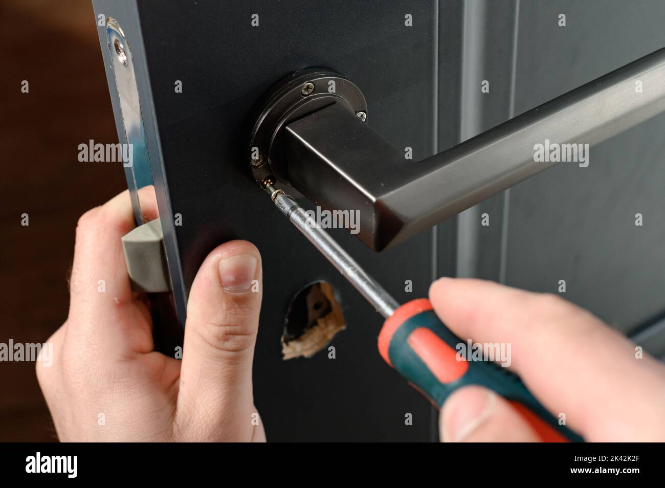 Installation of a door handle on interior doors, carpentry work with ...