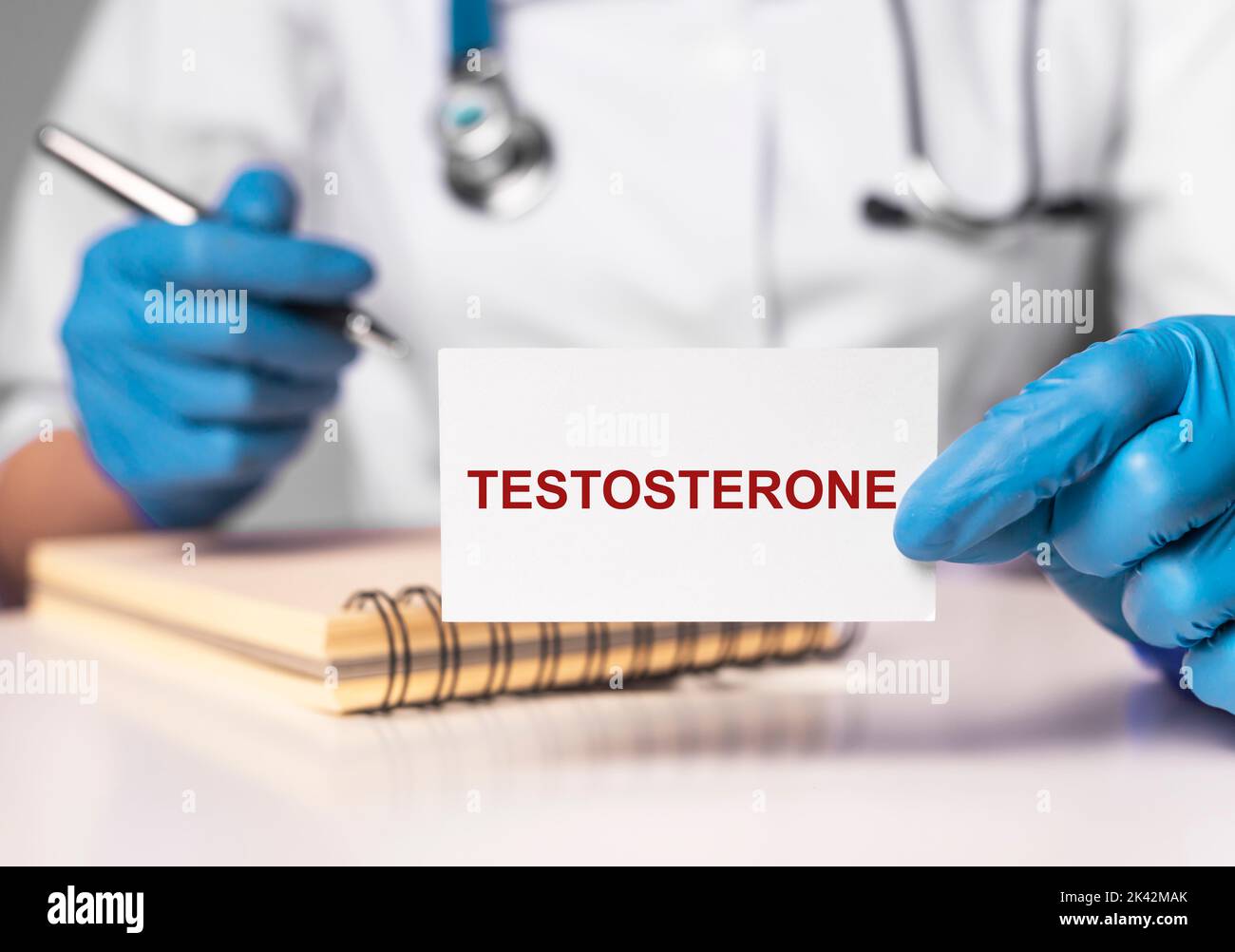 Testosterone hormone concept. Doctor sitting at table and taking notes ...
