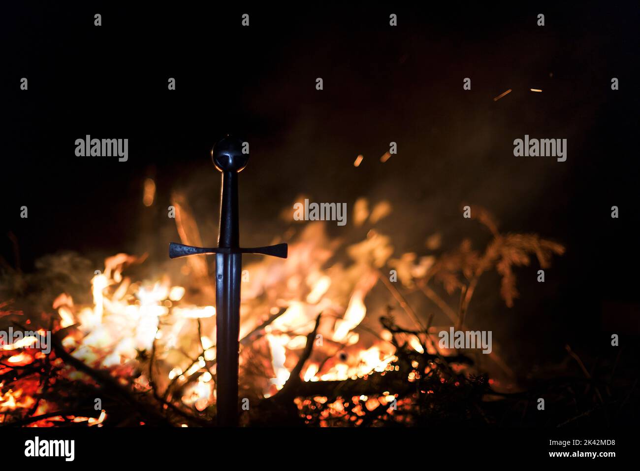 Close-up of Templar sword in ground by fire Stock Photo - Alamy