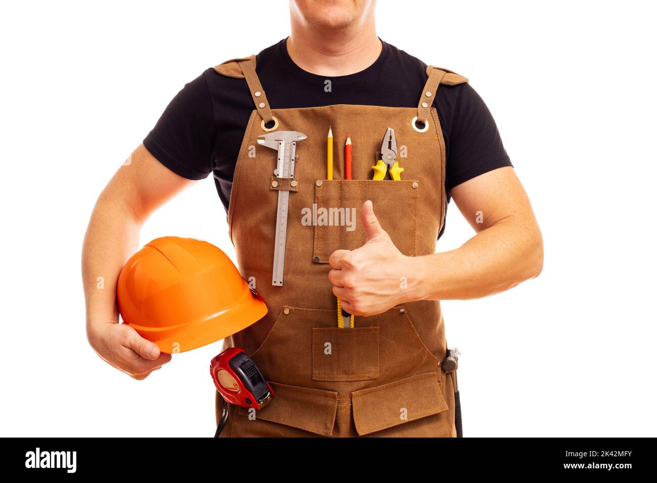 Contractor worker or carpenter in apron with tools and helmet holding ...