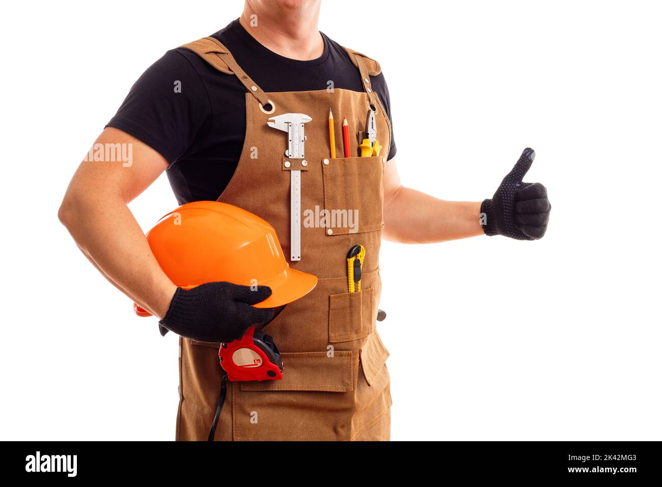 Contractor worker or carpenter in apron with tools and helmet holding ...