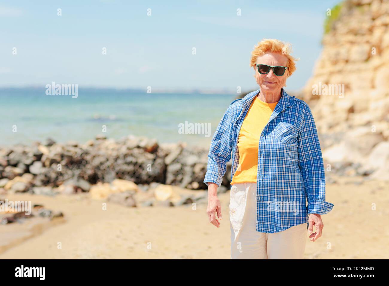 Mature woman relaxing on beach hi-res stock photography and images - Alamy
