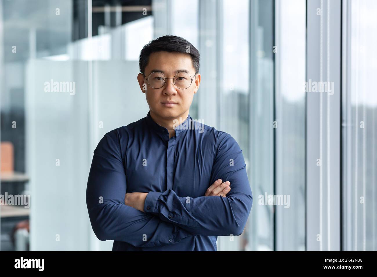 Portrait of successful and serious asian boss in shirt, man looking at ...