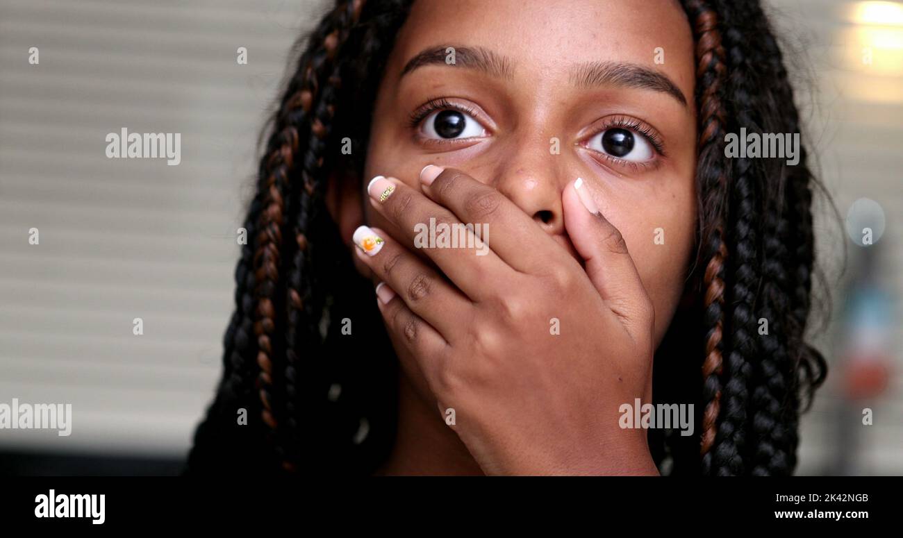 Child shocking reaction to news, black ethnicity girl suprised covering mouth with hand Stock ...