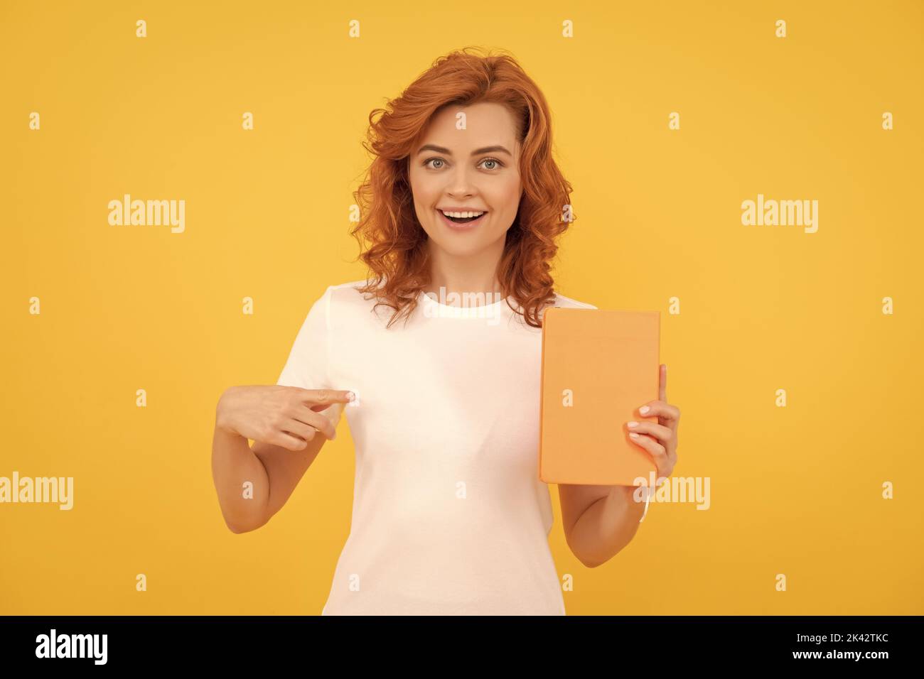 happy student on yellow background. girl study pointing finger on book ...