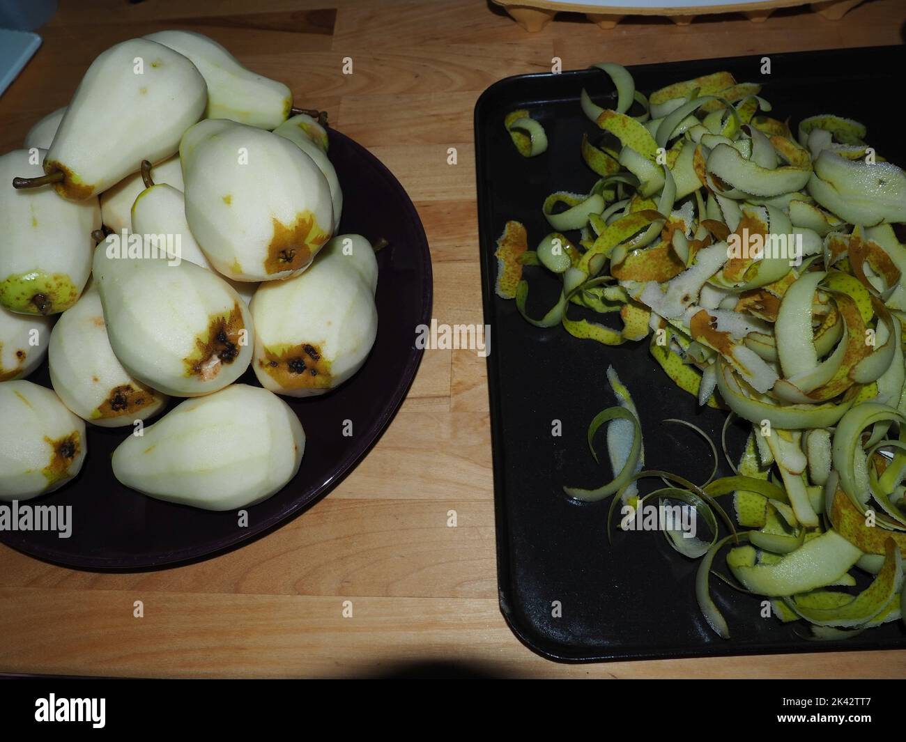 Pear preservation in process. Ripe fruit peeled on a metal tray and ...