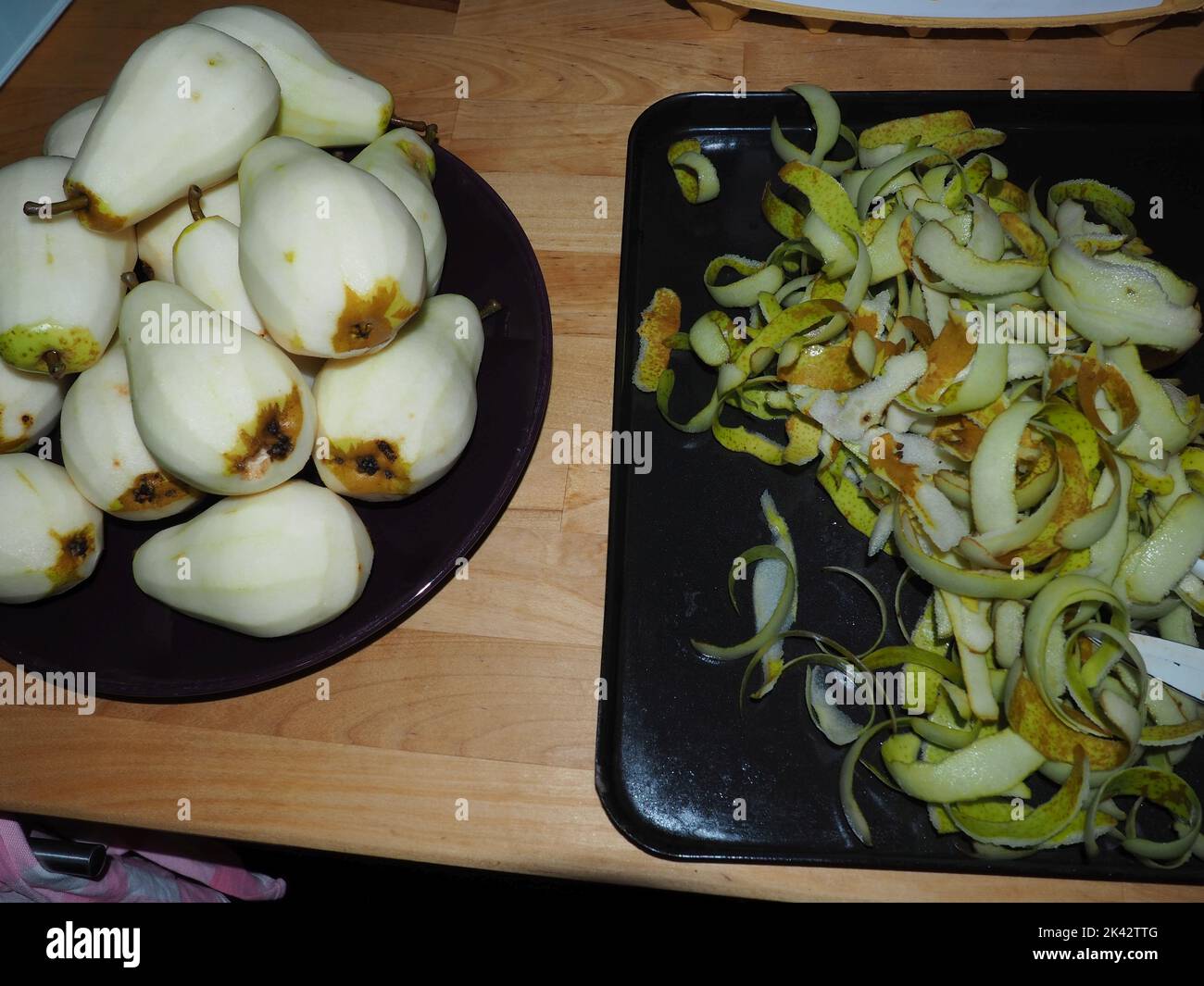 Pear preservation in process. Ripe fruit peeled on a metal tray and ...