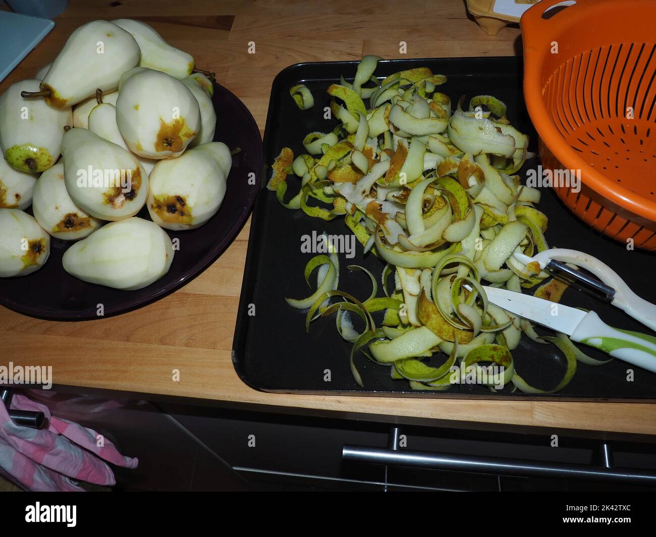 Pear preservation in process. Ripe fruit peeled on a metal tray and ...