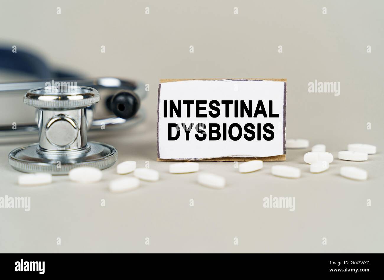 Medical concept. On a gray background, a stethoscope, pills and a ...