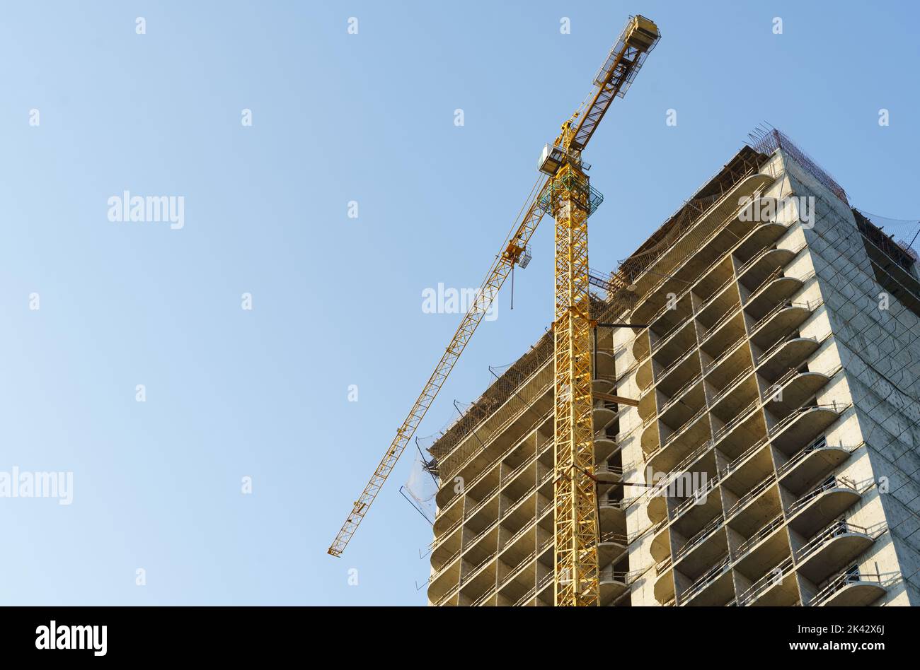 Bottom view of a crane working on the construction of apartments ...