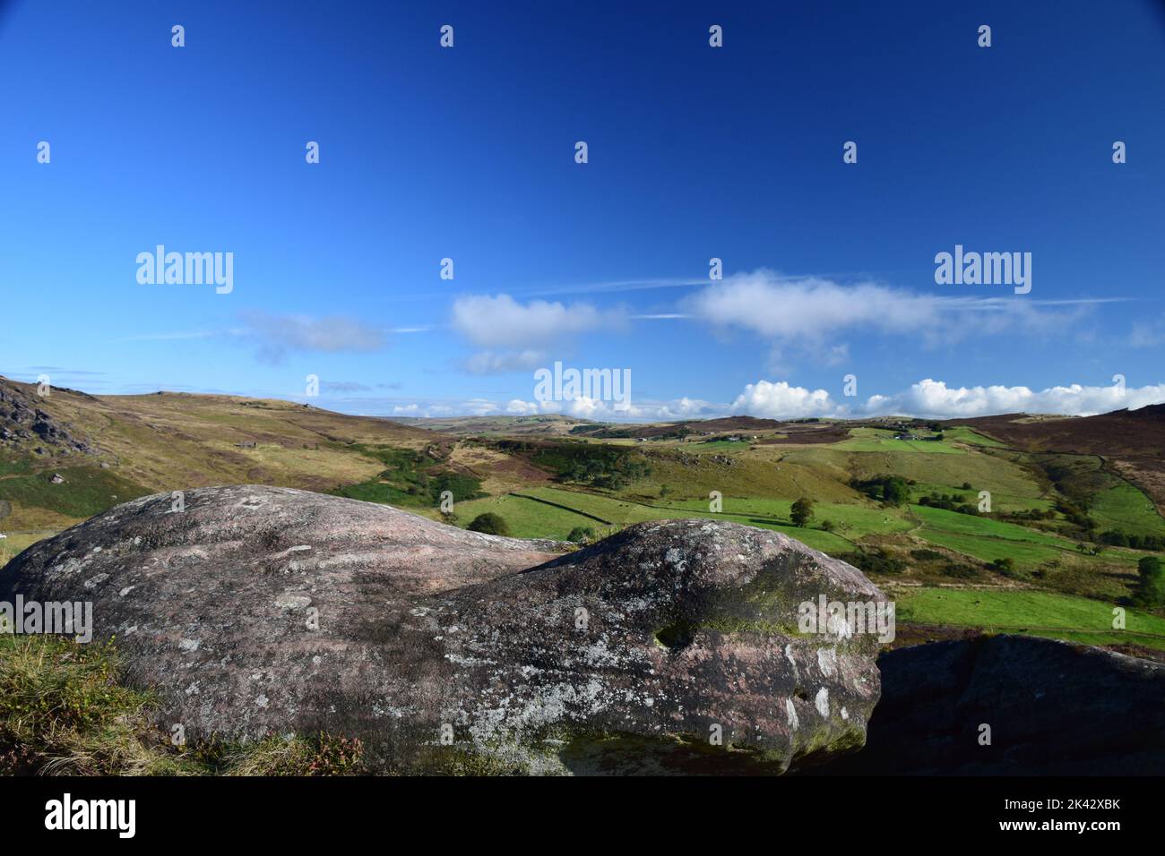 Blue sky and sunlight bathed the Roaches rocks and surrounding ...