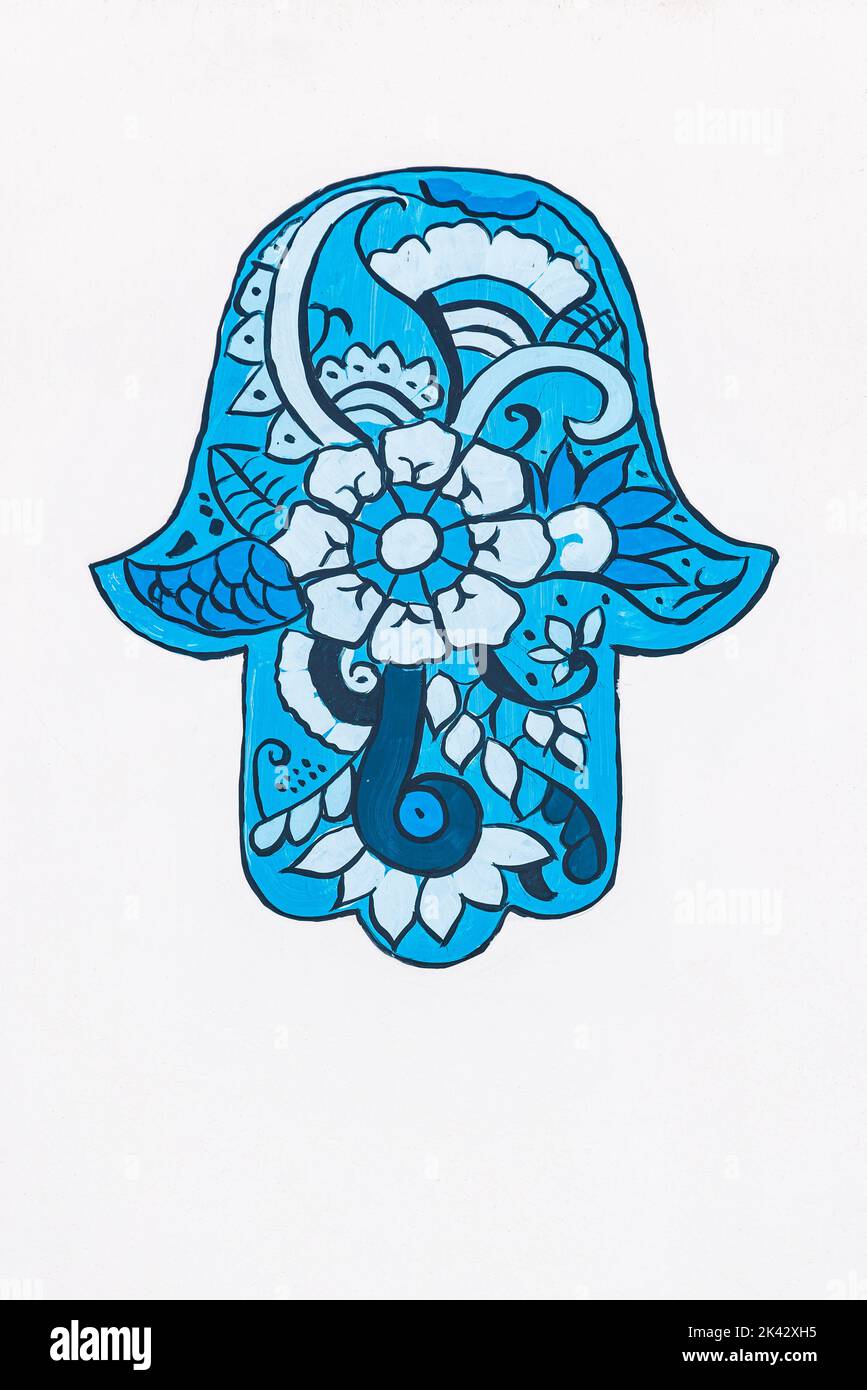 Cairo, Egypt. February 11, 2022. Blue hamsa symbol painted on a wall in ...