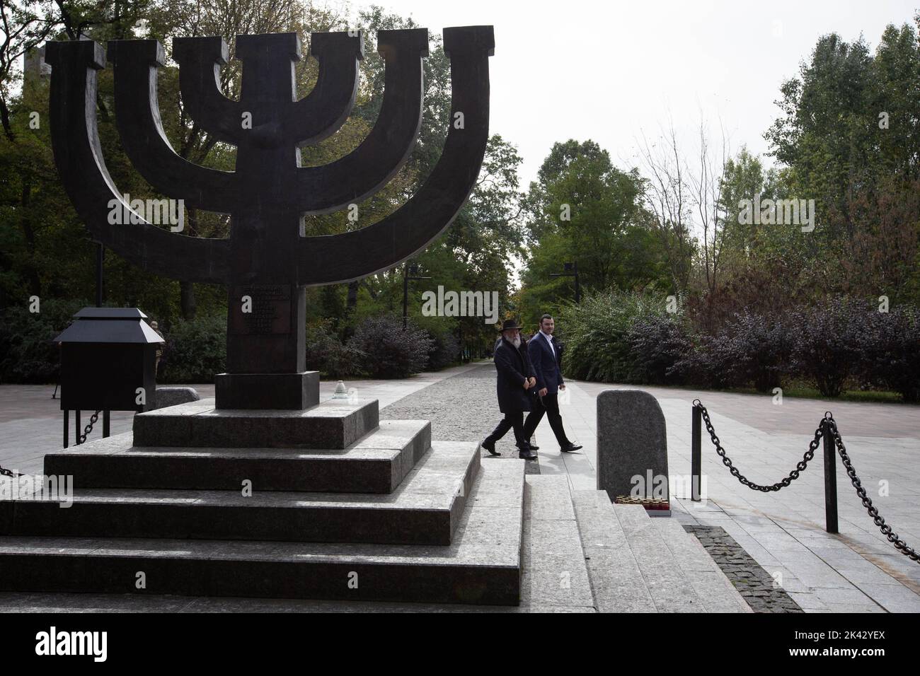 A rabbi walks past a monument commemorating the victims of Babyn Yar (Babiy Yar), one of the ...
