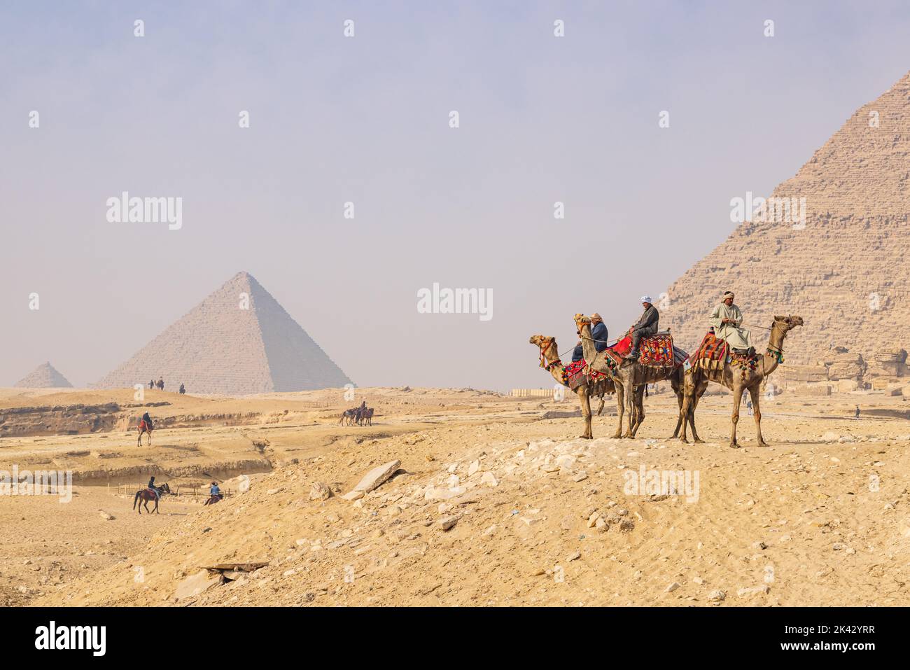 Giza, Cairo, Egypt. February 18, 2022. Men on camels at the Great ...