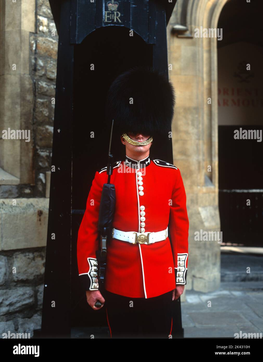 UK. England, The Tower, a foot guard in uniform, wearing the black ...