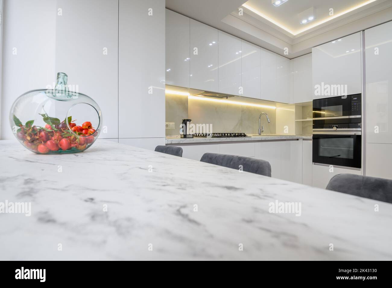 White kitchen interior, a vase with fruits at marble counter top Stock ...