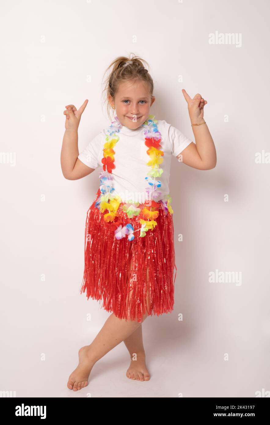 Full length portrait of little child girl in hawaiian costume pointing ...